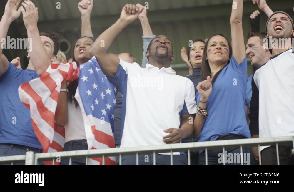 4K Excited fans with US flag in sports crowd, celebrating & cheering on ...