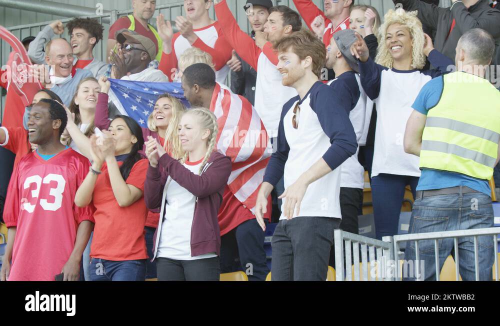 4K Excited fans with US flag in sports crowd, clapping & cheering on ...