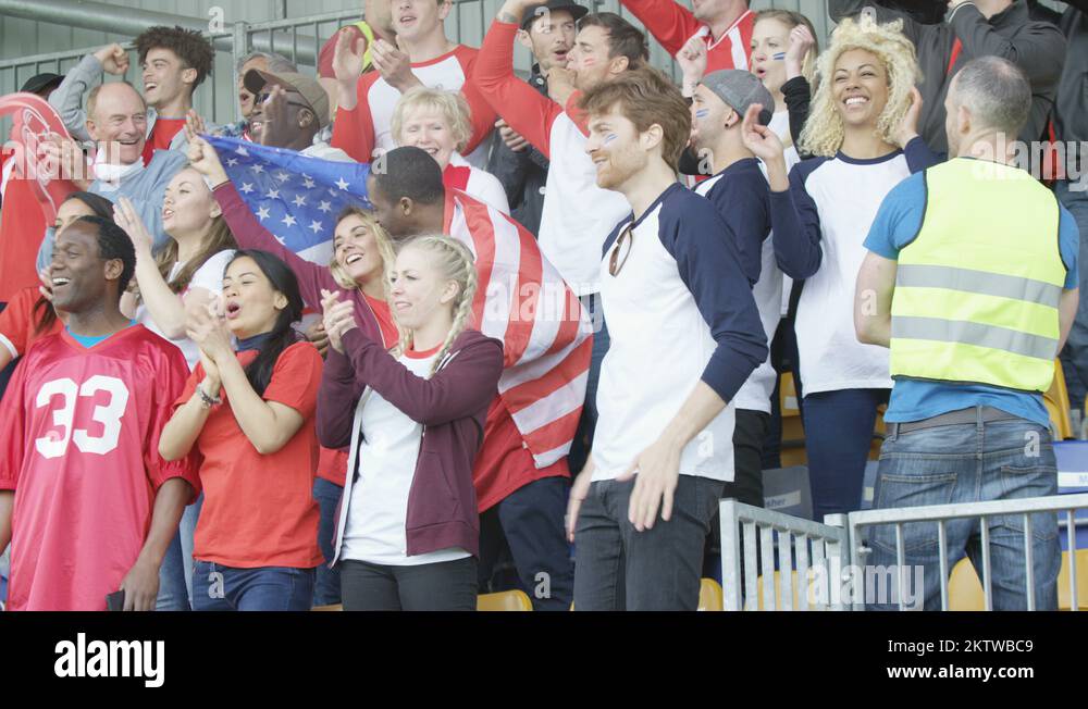 4K Excited fans with US flag in sports crowd, clapping & cheering on ...