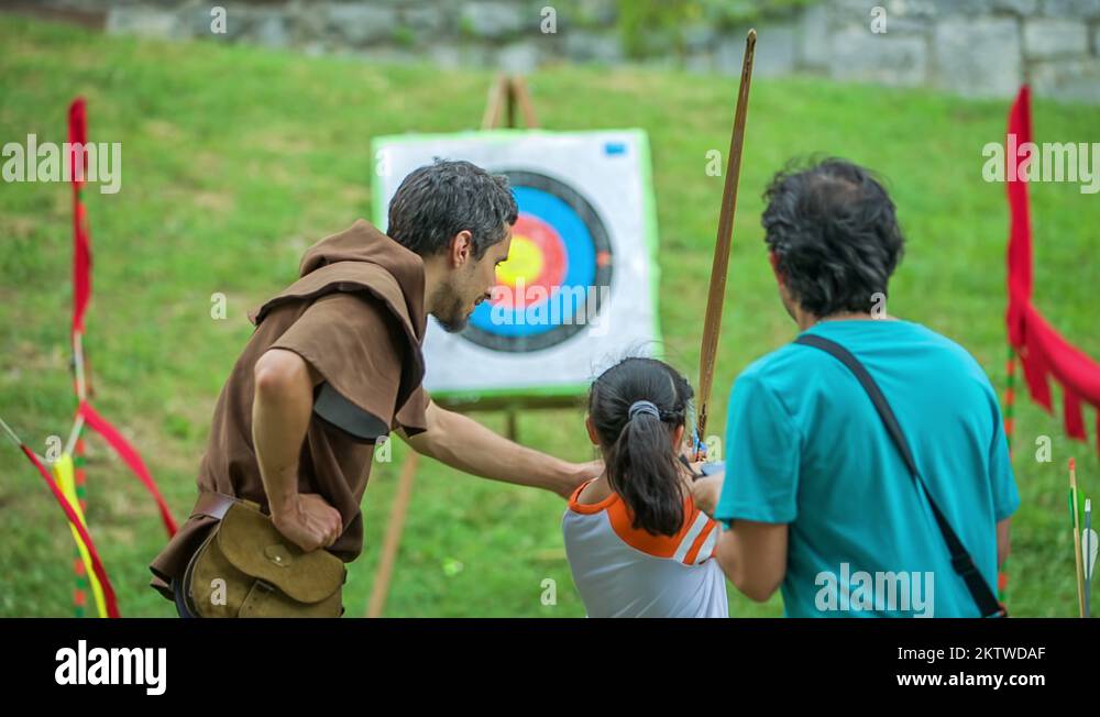 Young girl is trying to release the bow and she misses the target Stock ...