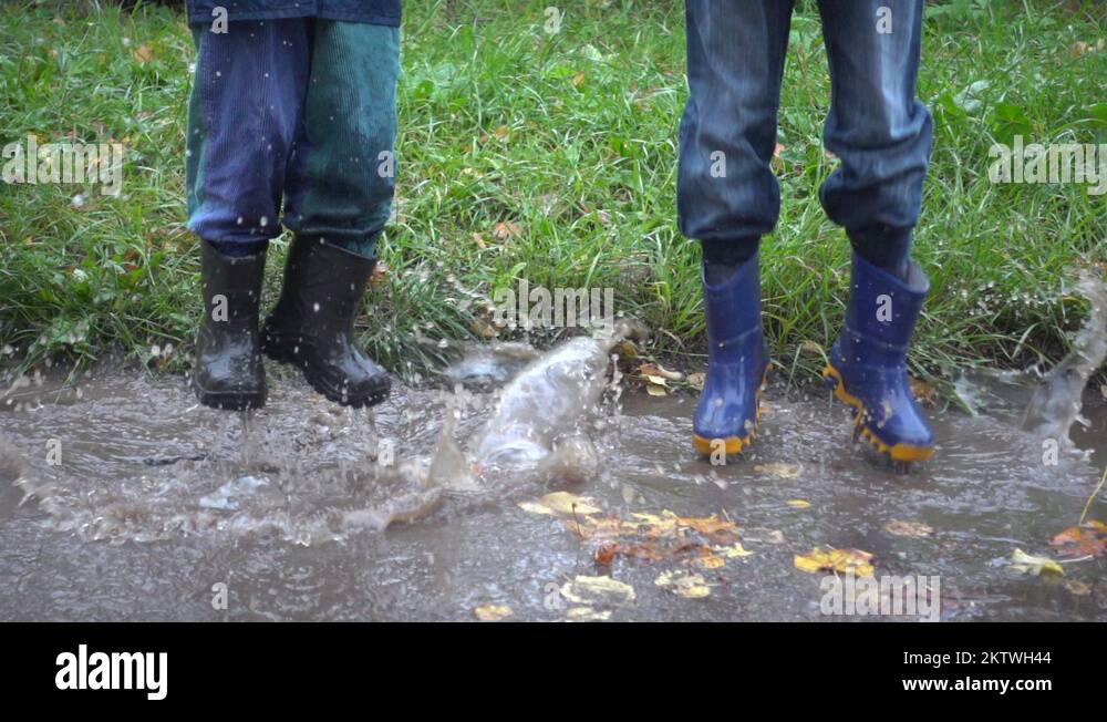 Two boys jumping in muddy puddle, slow motion 250 fps Stock Video ...