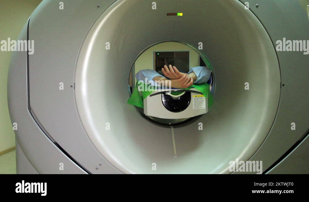 An MRI scanner in working process with patient on rolling desk Stock ...