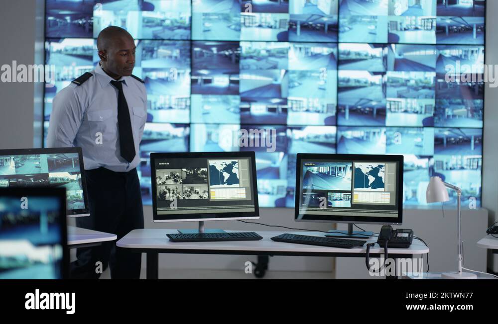 4K Security officer alone in observation control room does a little ...