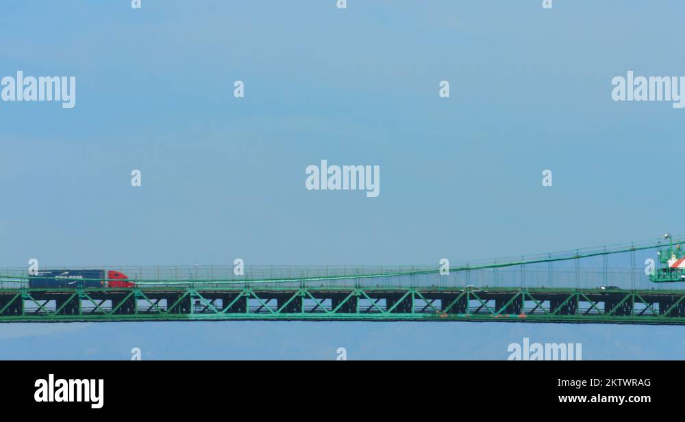 Trucks move cargo containers on the bridge at sea port in Los Angeles ...