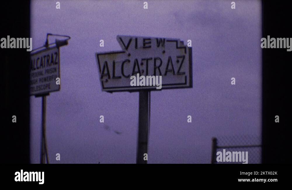 1968: view alcatraz sign next to fence on cloudy day with bird flying ...