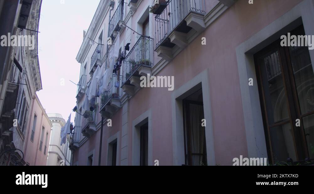 4K Row of apartments on a narrow Italian street with laundry hanging ...