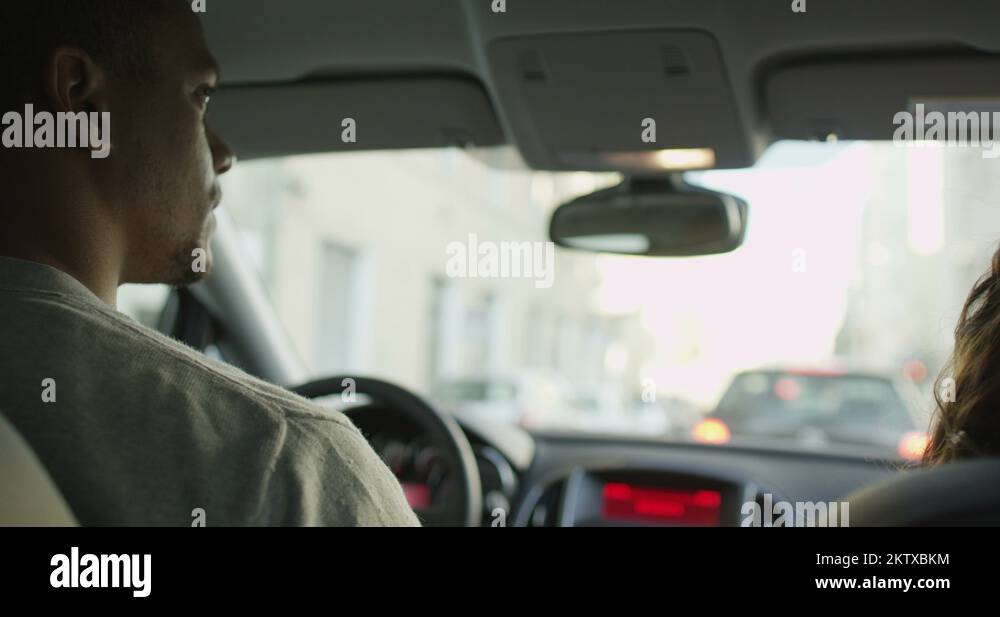 4K Romantic couple driving in car lean in to share a kiss Stock Video ...