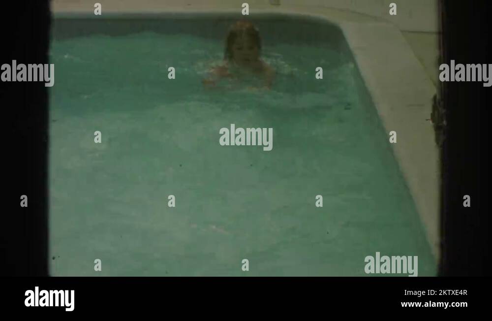 1971: young boy having a fabulous time swimming in the pool. MIAMI ...
