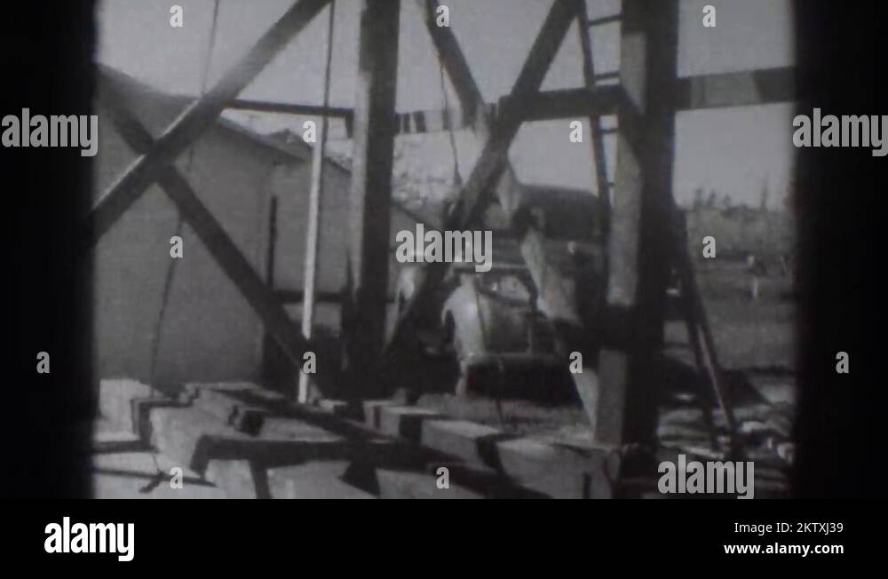 1937: men erect steel girders and beams atop tower next to completed ...