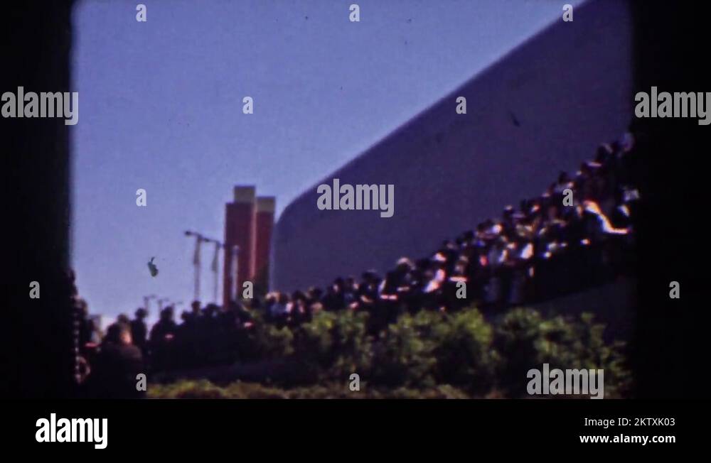 1939: a lot of people moving in queue through the side of a large ...