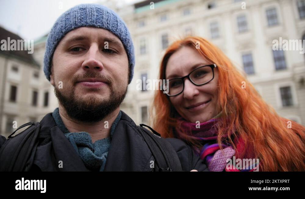 Young couple european beard man and red hair female makes a selfie in ...