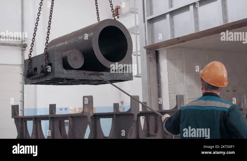 Steel ingot in the workspace, big red hot detail cooling water by crane ...