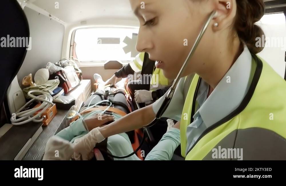 Paramedic using an external defibrillator during cardiopulmonary ...