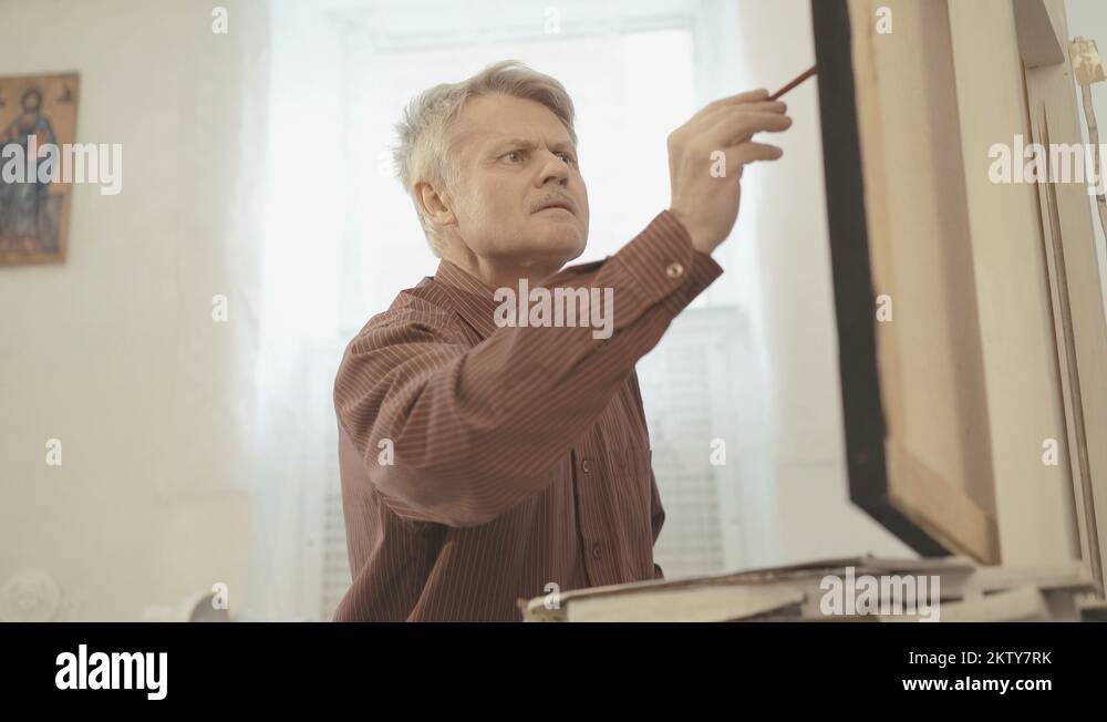 Portrait of old gray painter with mustache draws the masterpiece in 4K ...