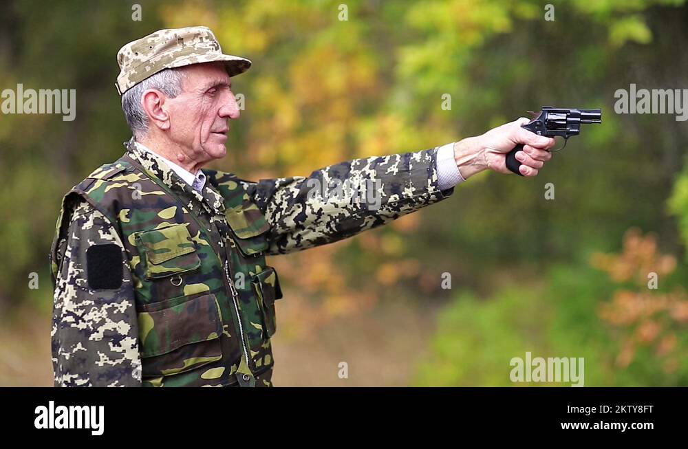 Elderly person in military uniform shoots a revolver Stock Video ...
