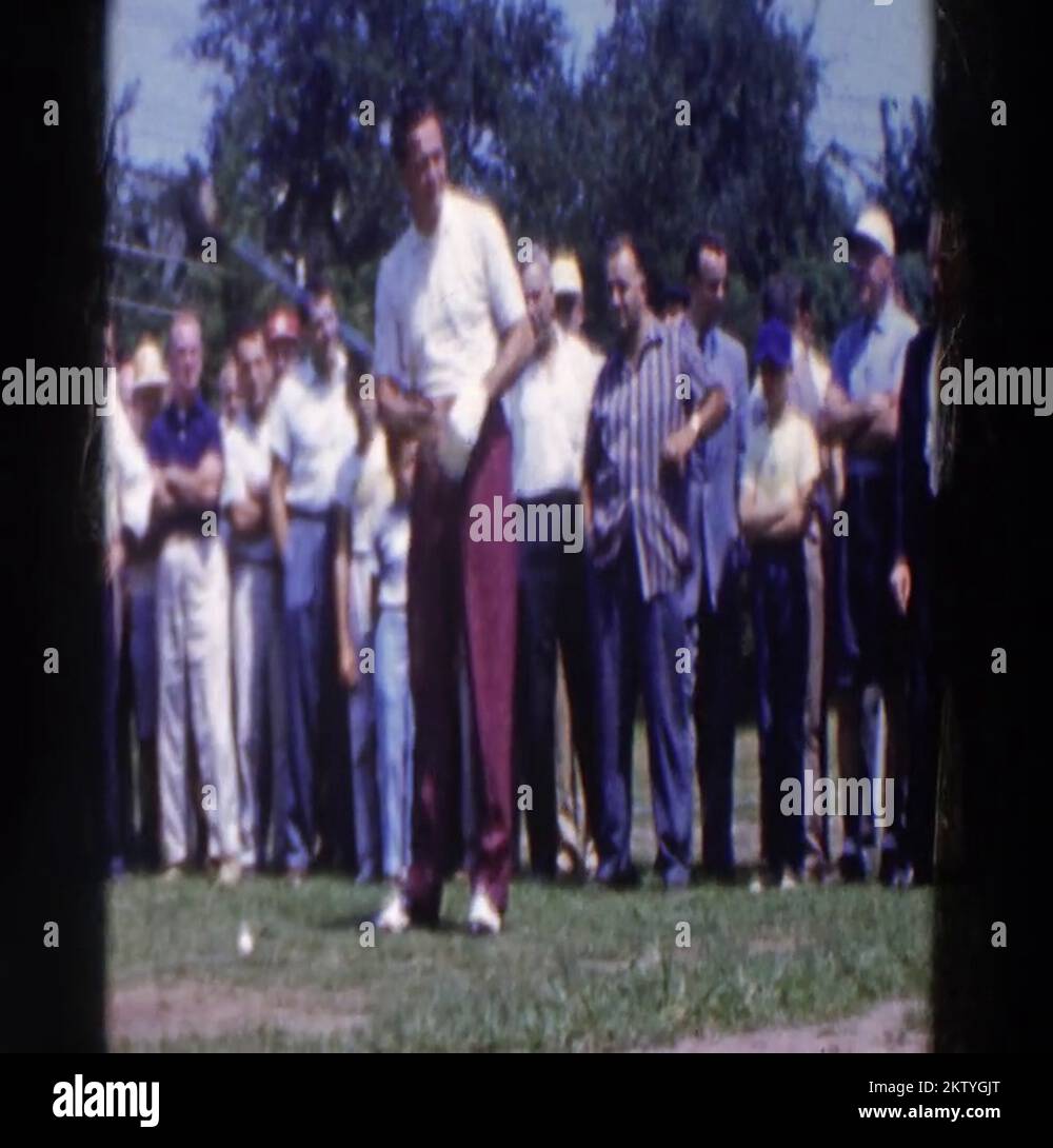 1961: group of people watching a man swing during his turn at golfing ...