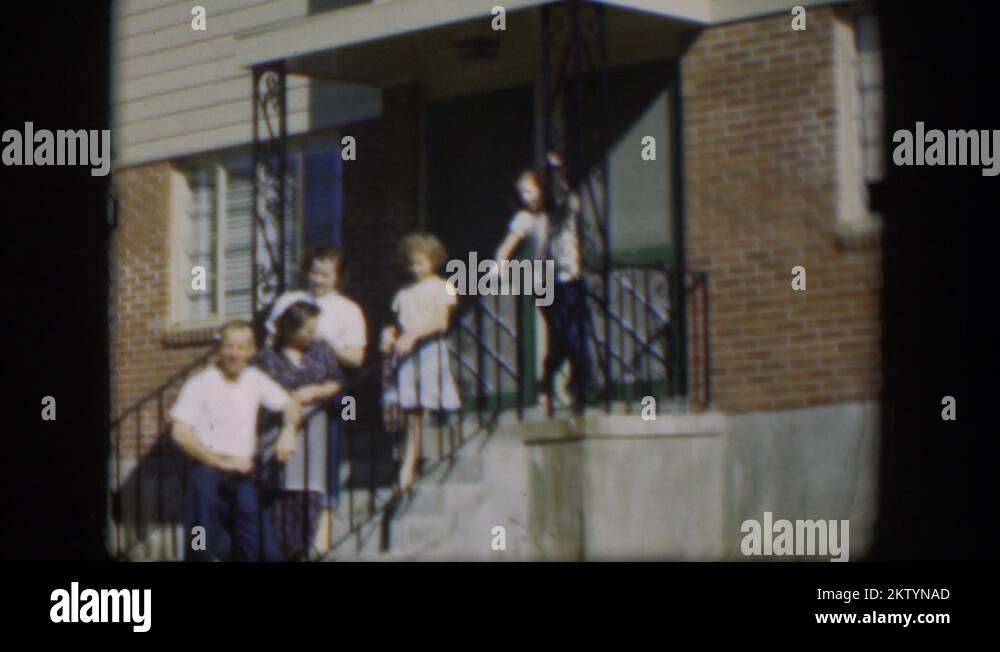 1954: people lined up against a railing waving happily to the audience ...