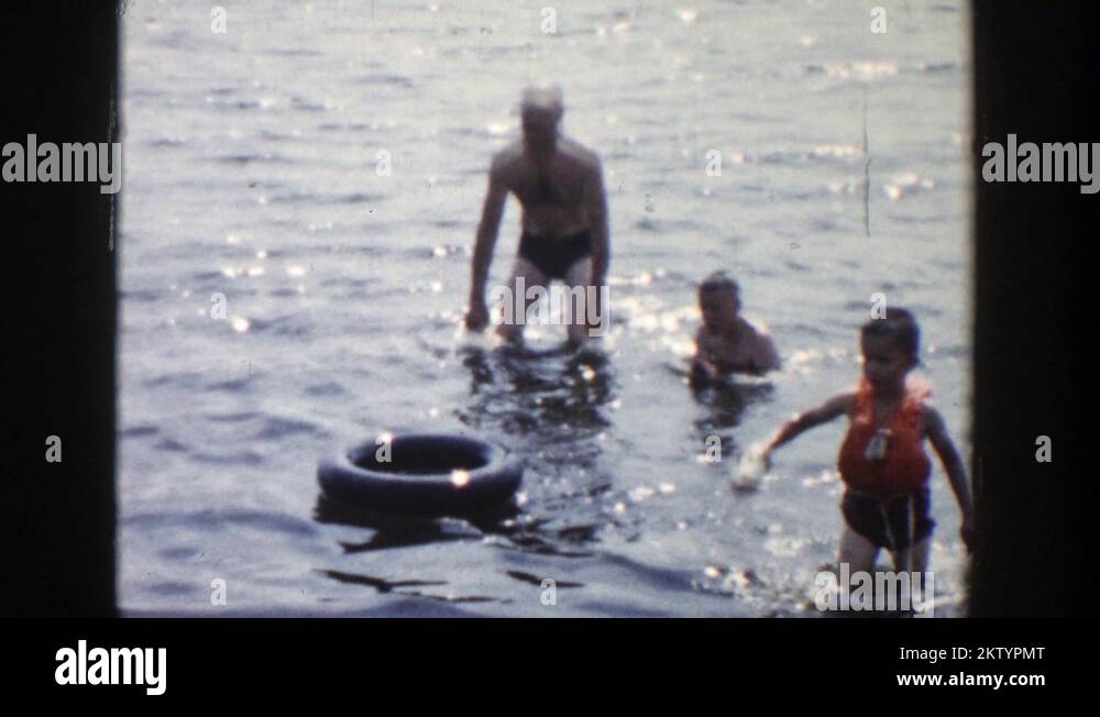 1958: children playing with their father in the lake. WISCONSIN Stock ...