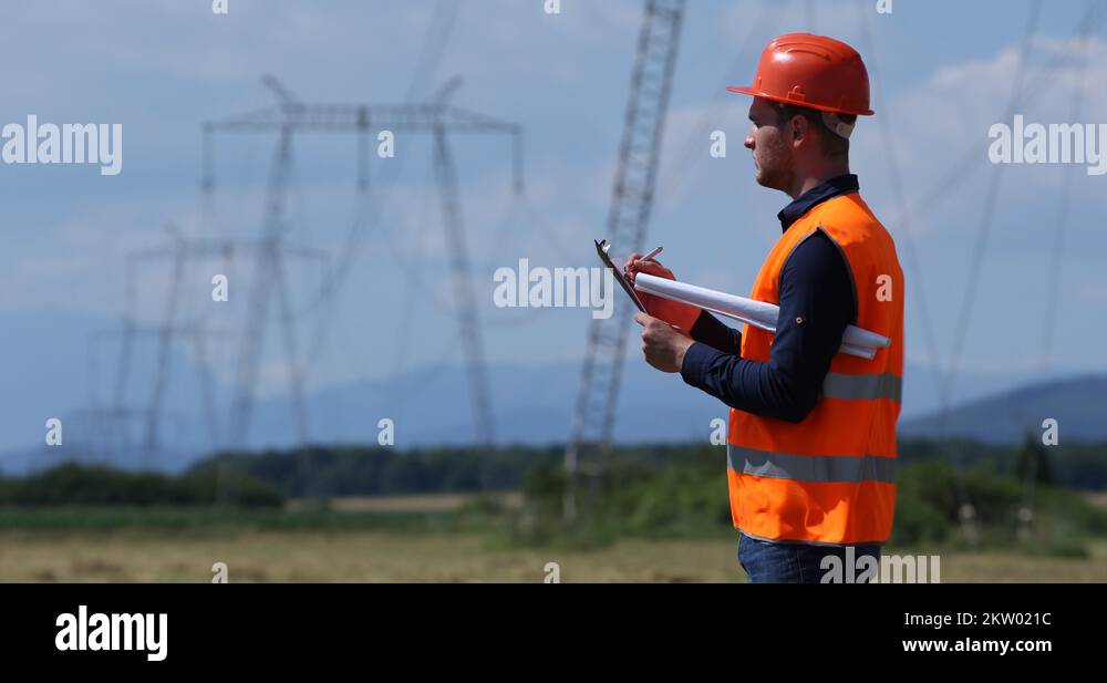 Engineer Worker Man Taking Notes About Wire High Voltage Power Lines ...