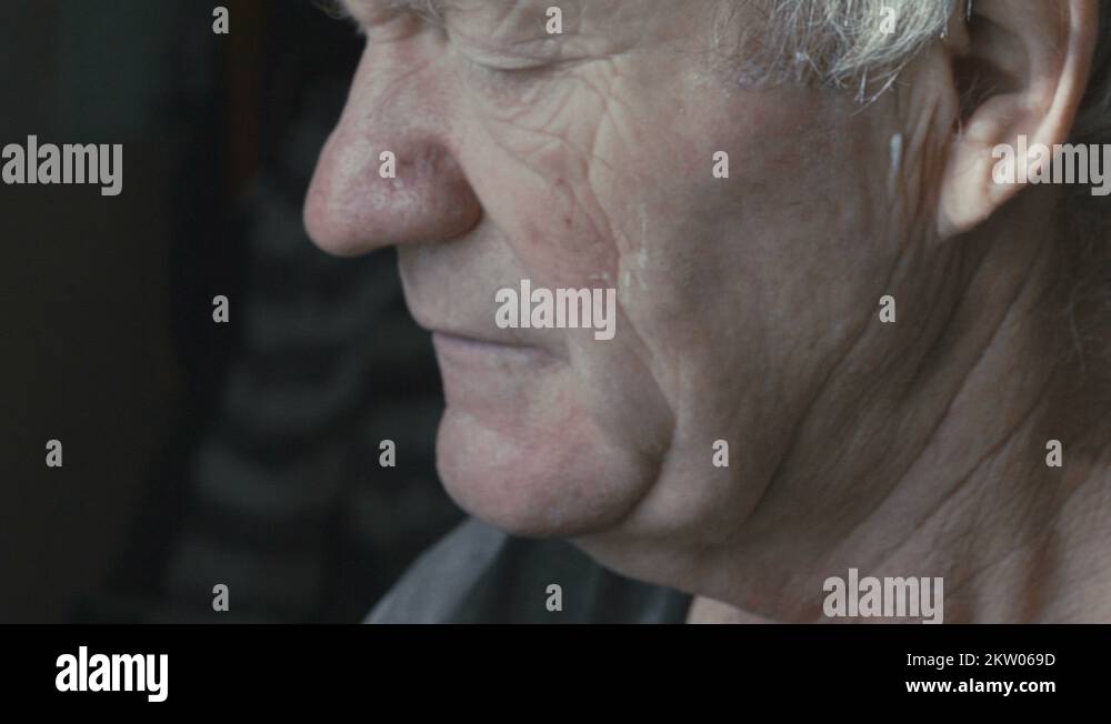 Old gray man shaving beard on face by himself Stock Video Footage - Alamy