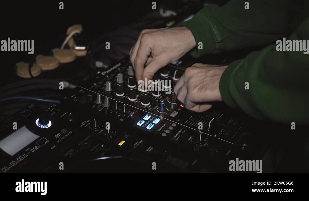 DJ hands on equipment making scratch in nightclub. Disk Jockey on open ...