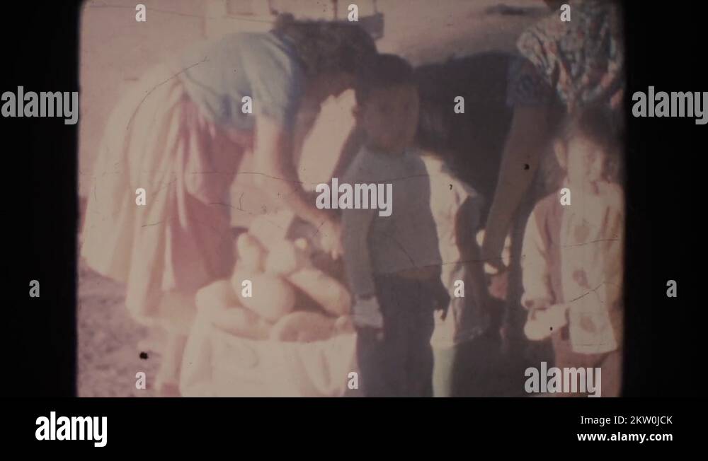 1951: two women baking bread stand by clay oven near fresh loaves while children Stock Video ...