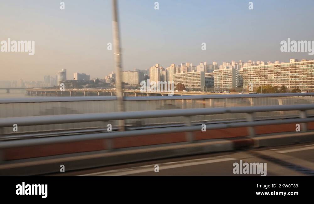 Cityscape of highrise apartment buildings from window of car moving ...