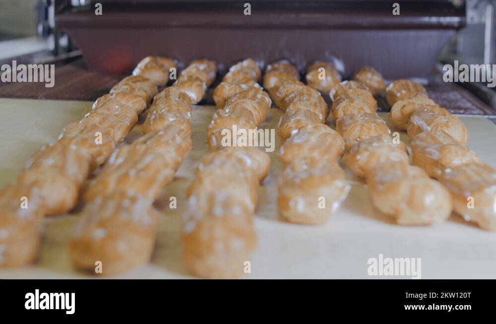 Cookies baking in the industrial oven. Cakes and cookies production ...