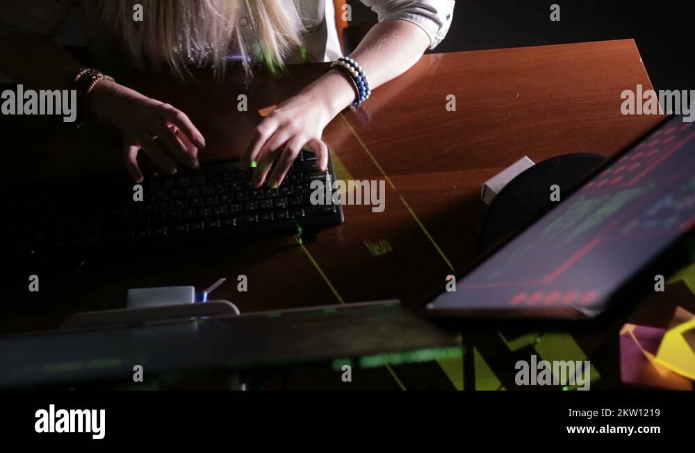 Female Hands Typing Computer Code Hacking Computer At A Dark Room