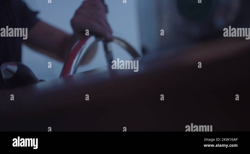 Captain on deck of large ship steering a wheel. Sailor at the helm of a ...