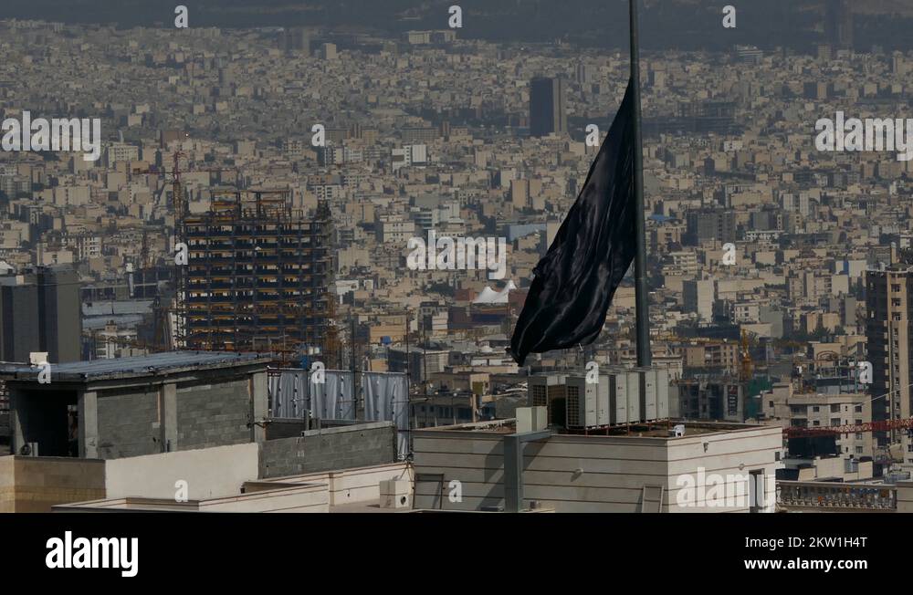 Black flag the symbol of Islam waving in wind over buildings of a big city Stock Video Footage ...