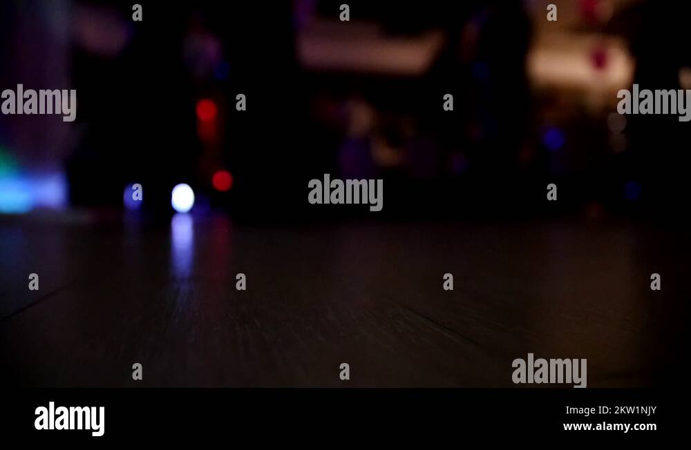 Legs of many men and women on dance floor at night club, slow-motion ...