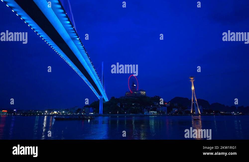 The Bai Chay Bridge in Ha Long, Vietnam lit up with colorful lighting ...