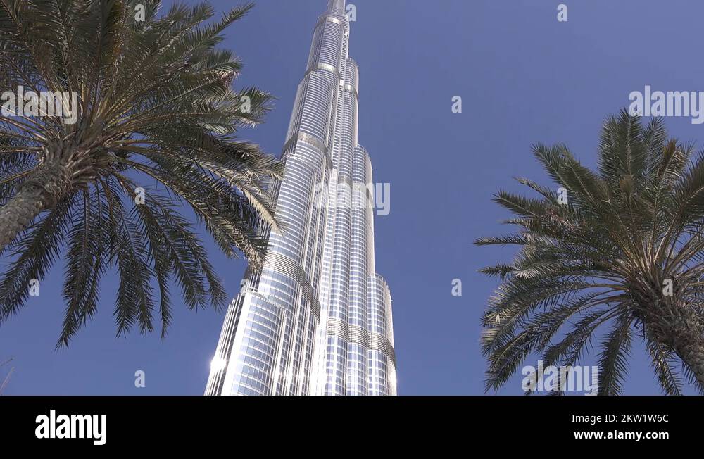 Dubai emirate luxury development Burj Khalifa and arabic palm trees in ...