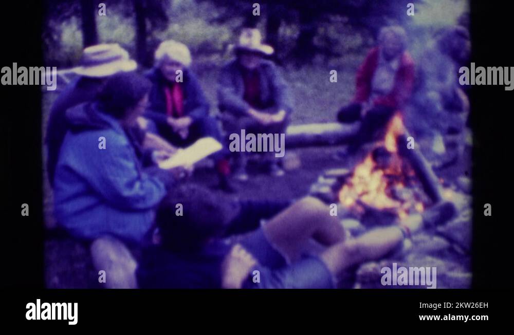 1975: a group of people sitting around a fire on a camping trip AGATE ...