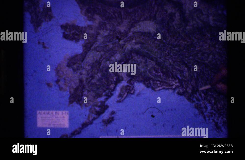 1977: person hand shown using a object to navigate over a map. ALASKA ...