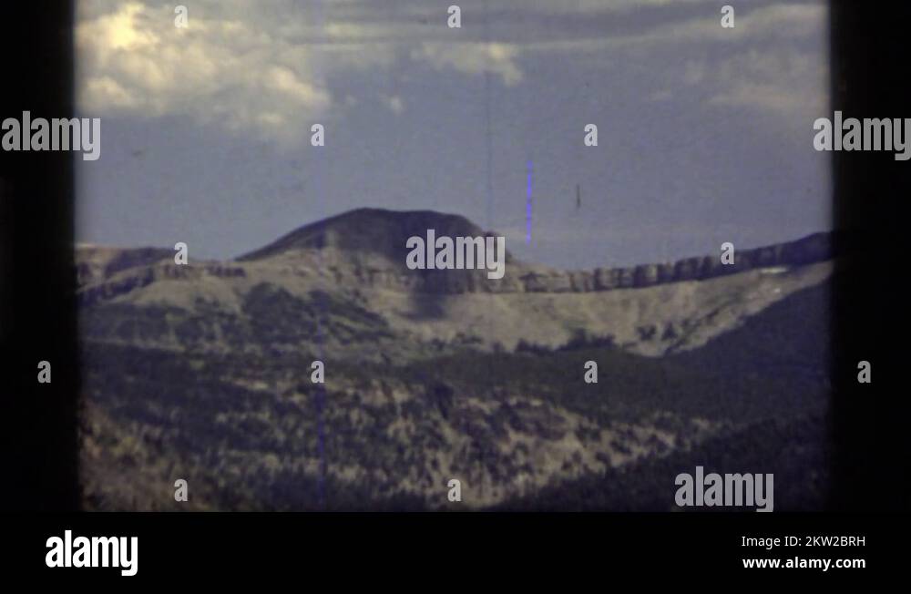 1977: a mountain peak rises above surrounding mountains and juts into a ...