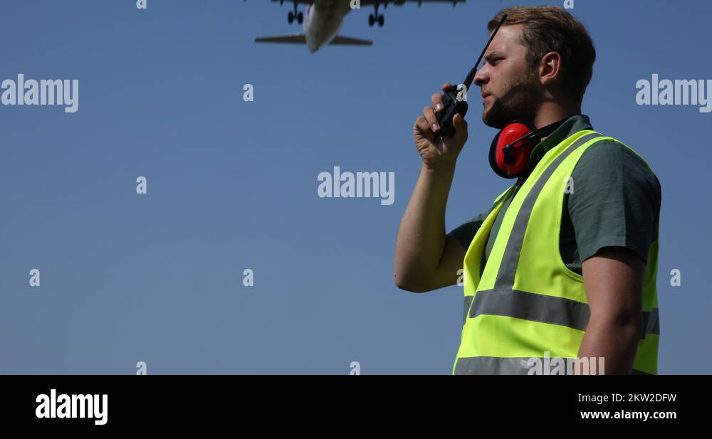 Airport Staff Call Using a Walkie Talkie Radio Giving Instructions Job ...