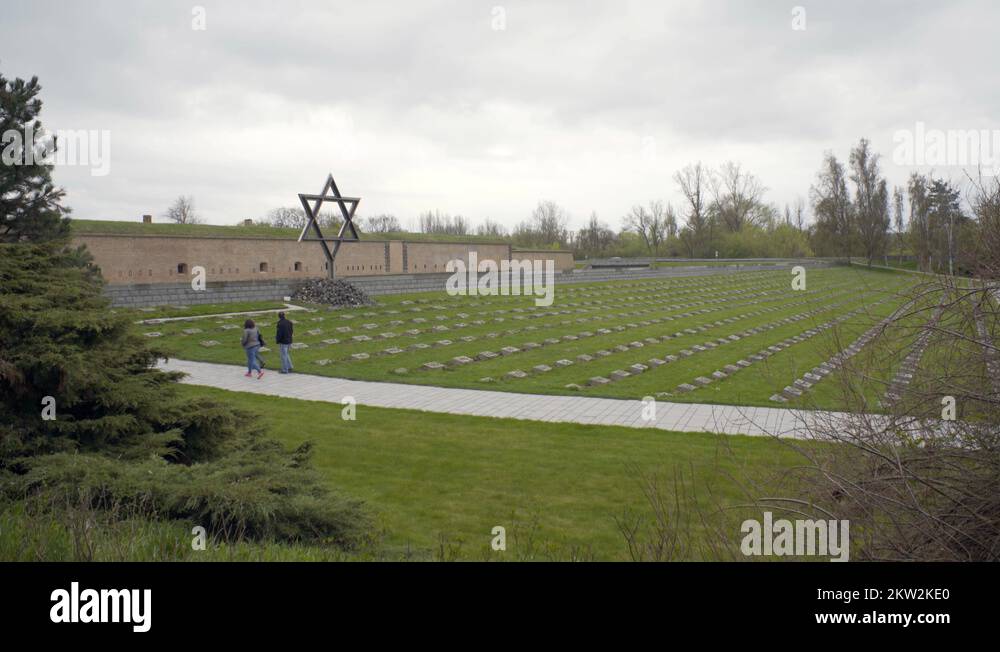 People walk across Theresienstadt victims memorial graves, Jewish star ...