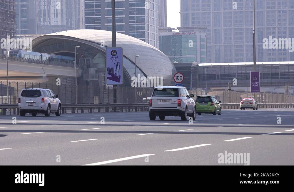 Dubai metro 4K subway train enter in station cars drive fast on freeway ...