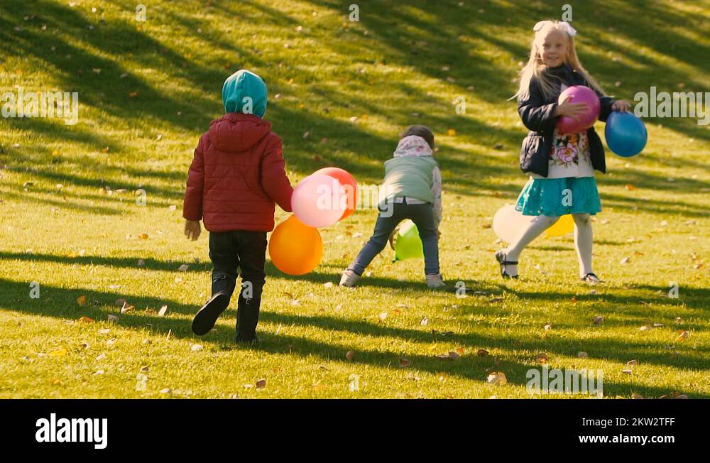 Little kids playing with balloons outdoors Stock Video Footage - Alamy