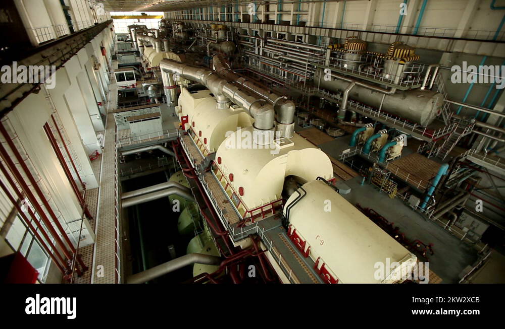 A turbine generator in the engine room of a nuclear power plant. HD ...