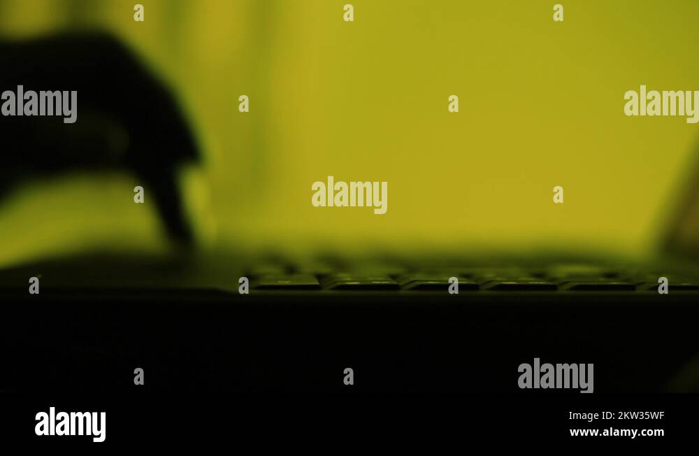 Silhouette of male hand using slider and typing on a keyboard in the ...