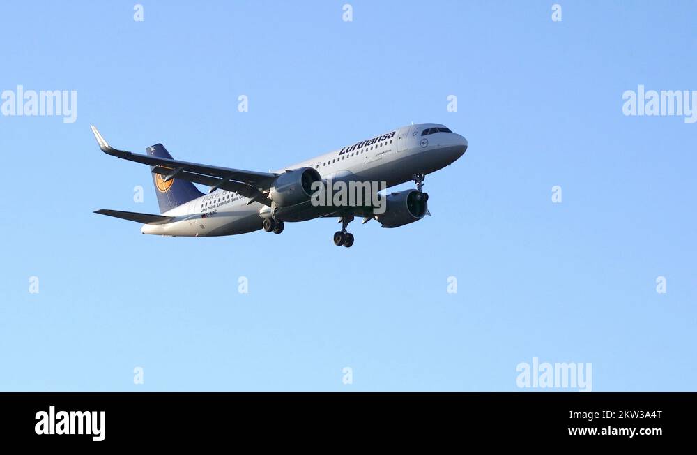 Lufthansa Airbus A320 Neo overhead left to right behind trees Stock ...