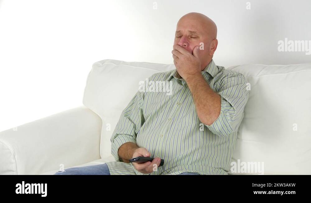 Tired Businessman Yawn Use a TV Remote Falling Asleep in Front of ...
