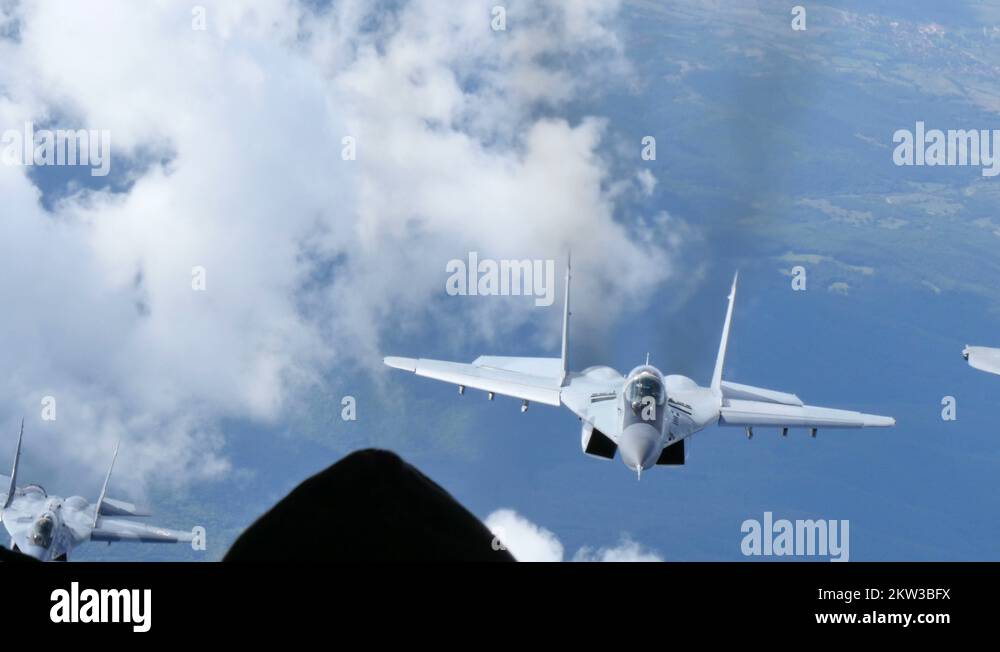 Photographers on a Cargo Aircraft take pictures of MiG-29 fighter jets ...