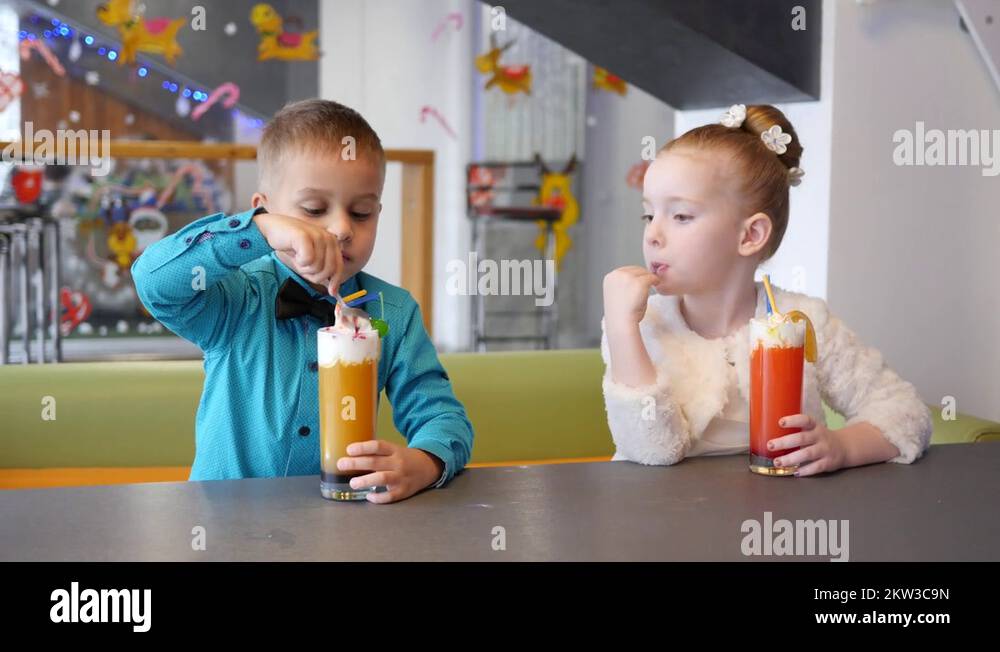 Milkshake cocktail - children in cafe cute little girl and boy eat ...