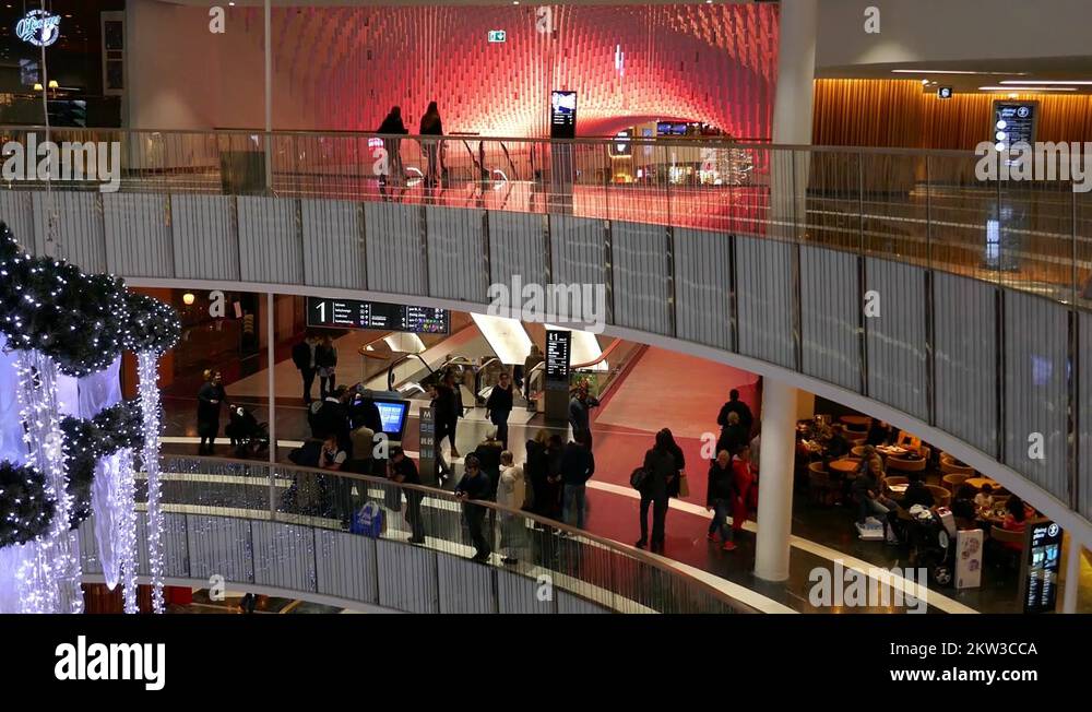 Tilt down of people walking shopping inside mall of Scandinavia center ...