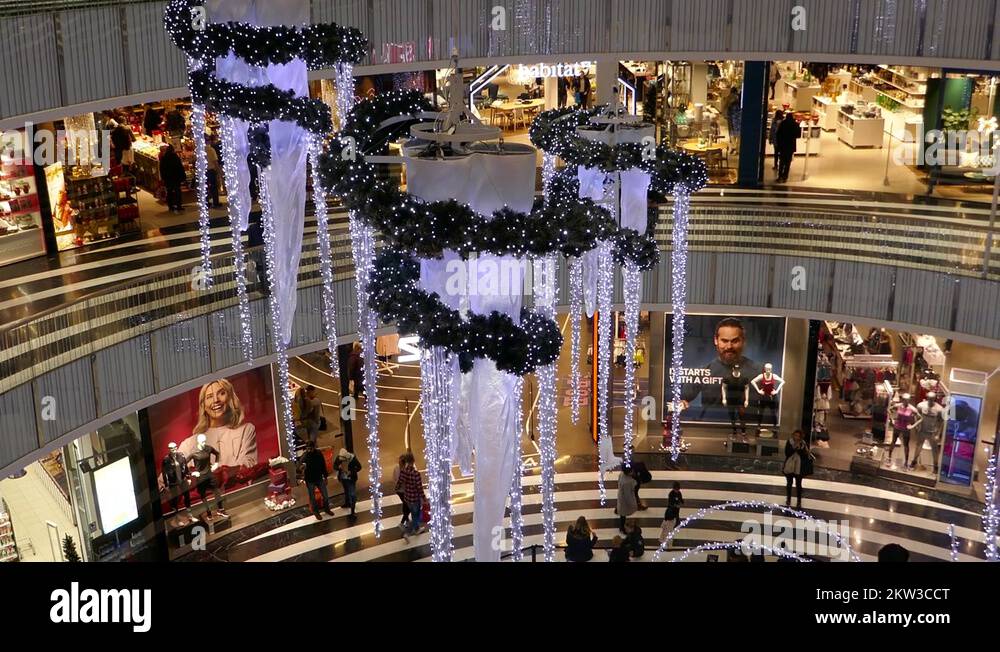 Tilt down of people inside mall of Scandinavia shopping center during ...