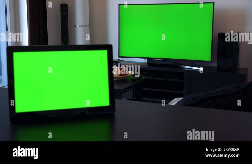 A tablet on a desk in a horizontal position - a TV - green screen Stock ...